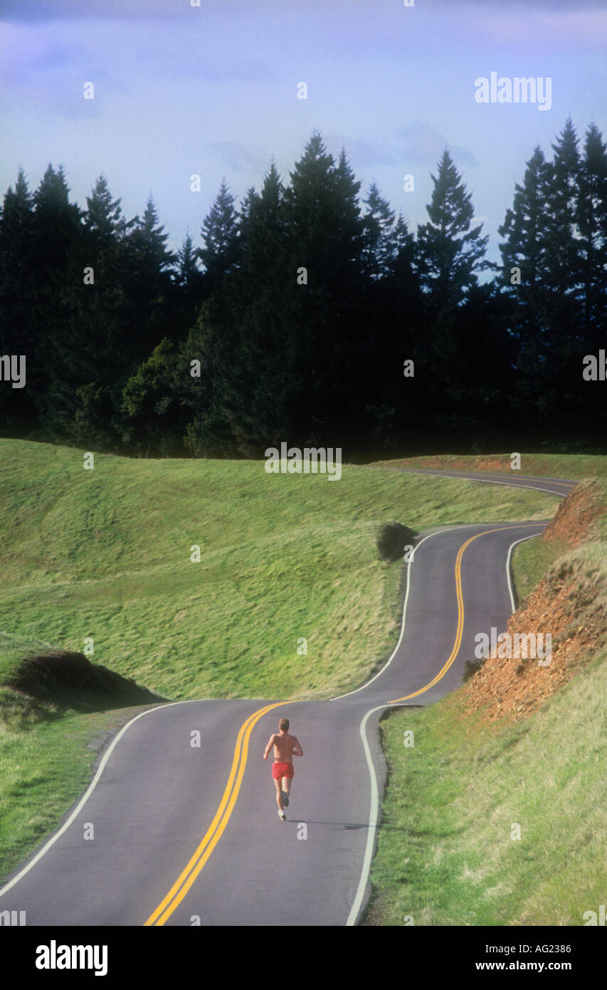Lonely runner on road hi-res stock photography and images - Alamy