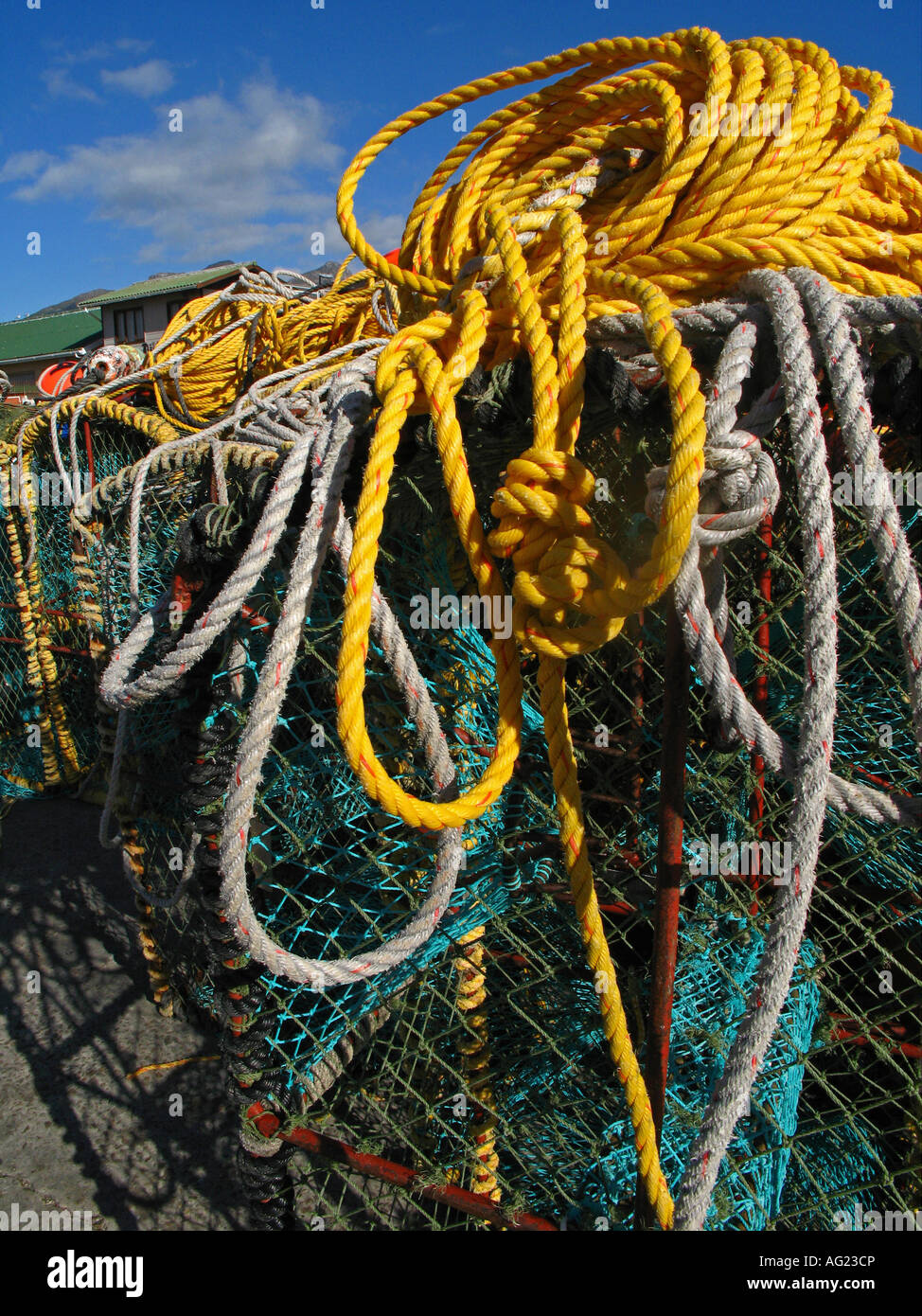Crayfish cages on the harbour wall waiting to be loaded onto a trawler ...