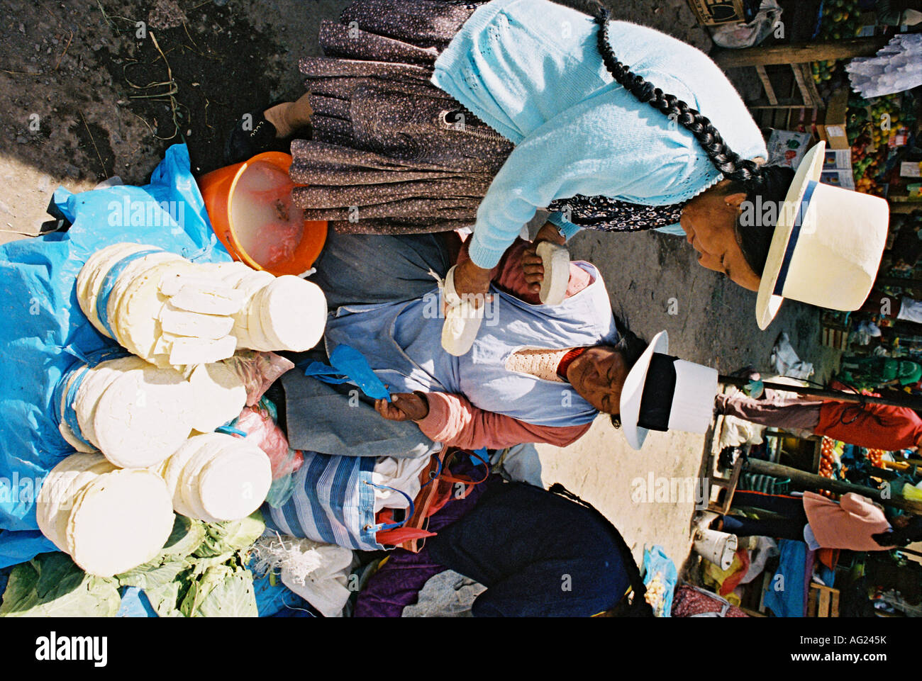 andean indian woman selecting cheese at a market stall Stock Photo - Alamy