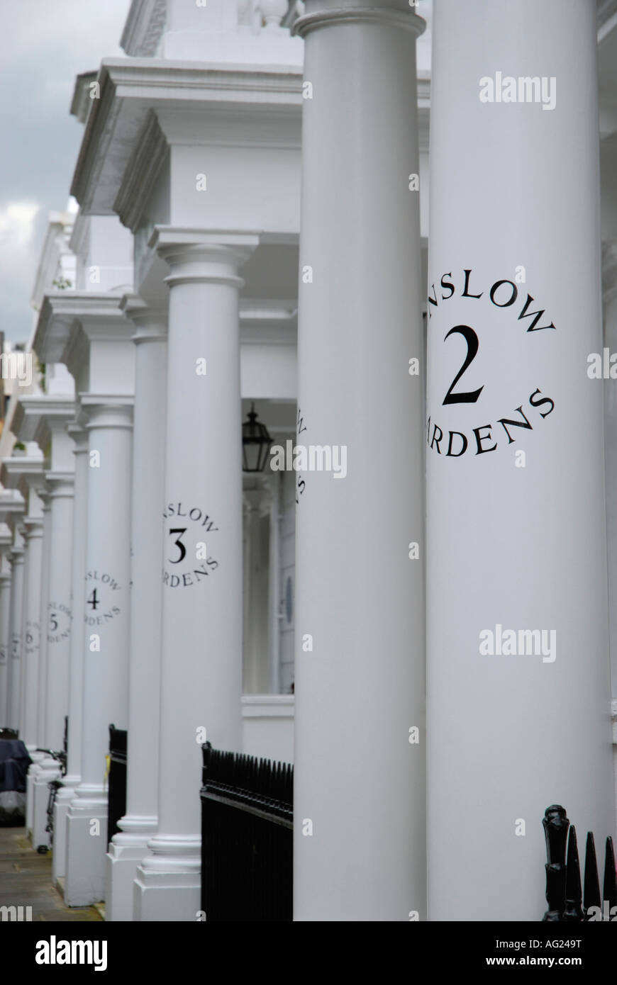 White numbered columns outside grand Victorian houses in Chelsea London ...