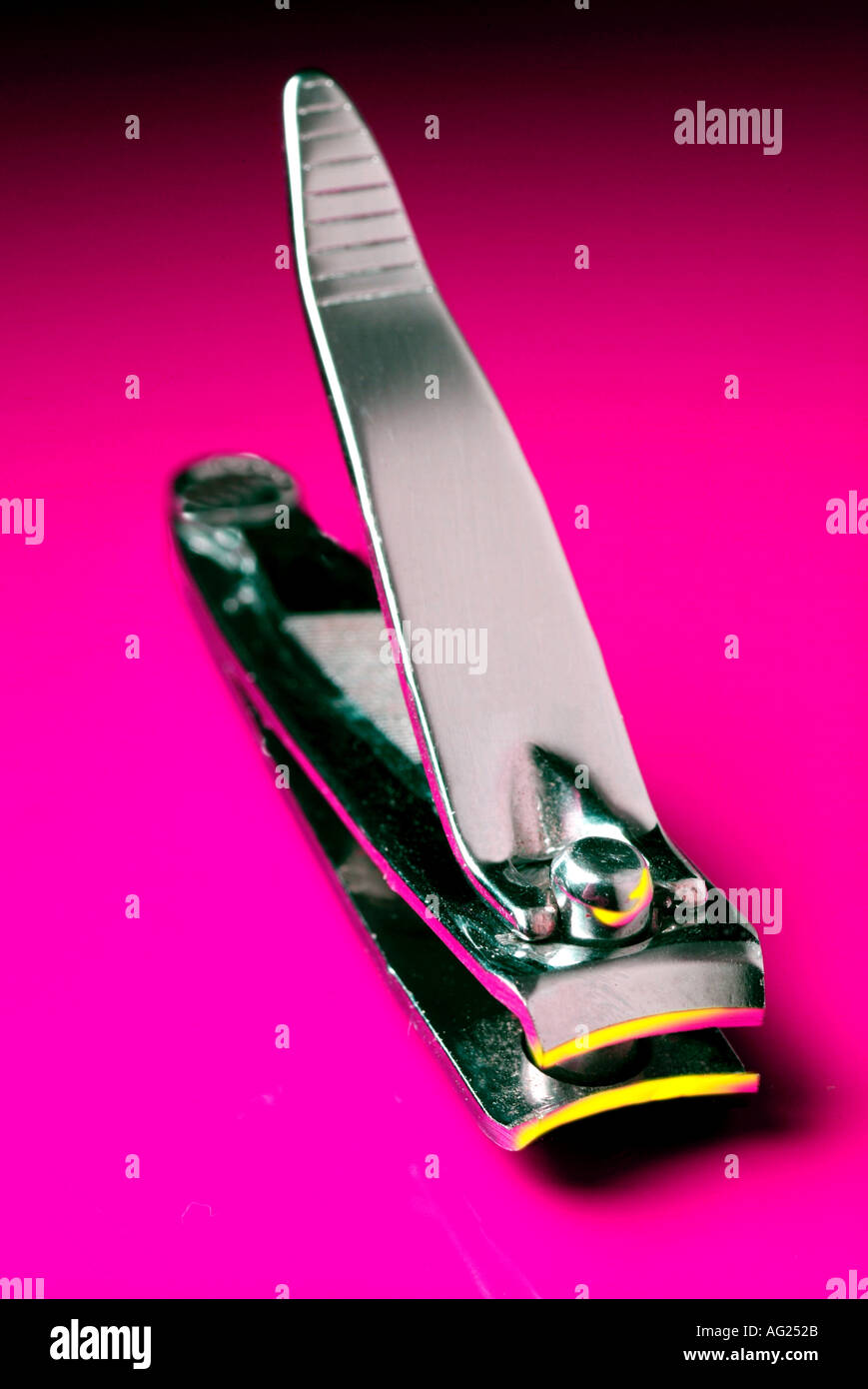 Fingernail clippers on bright purple background Stock Photo - Alamy