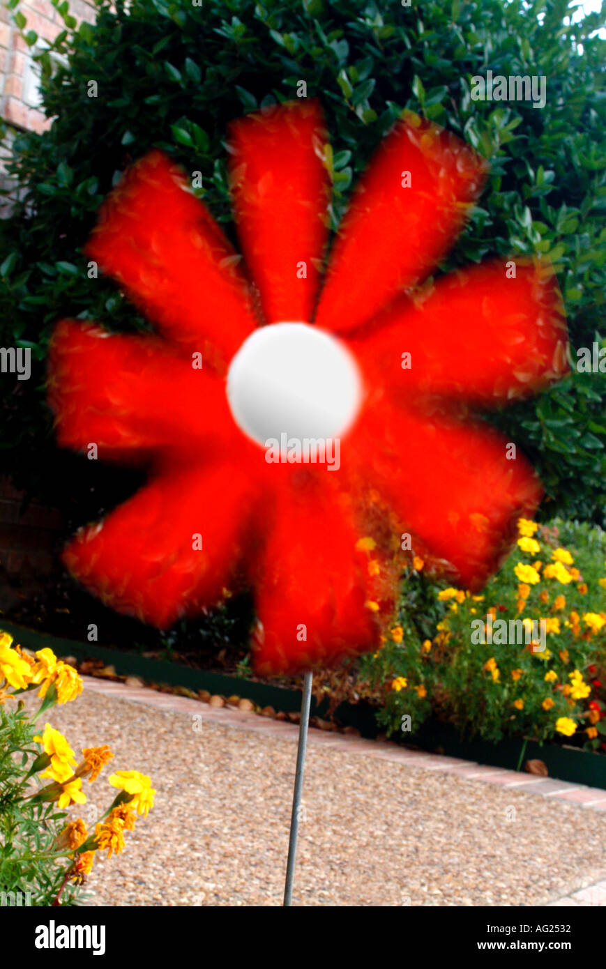 Red pinwheel spinning in garden Stock Photo - Alamy