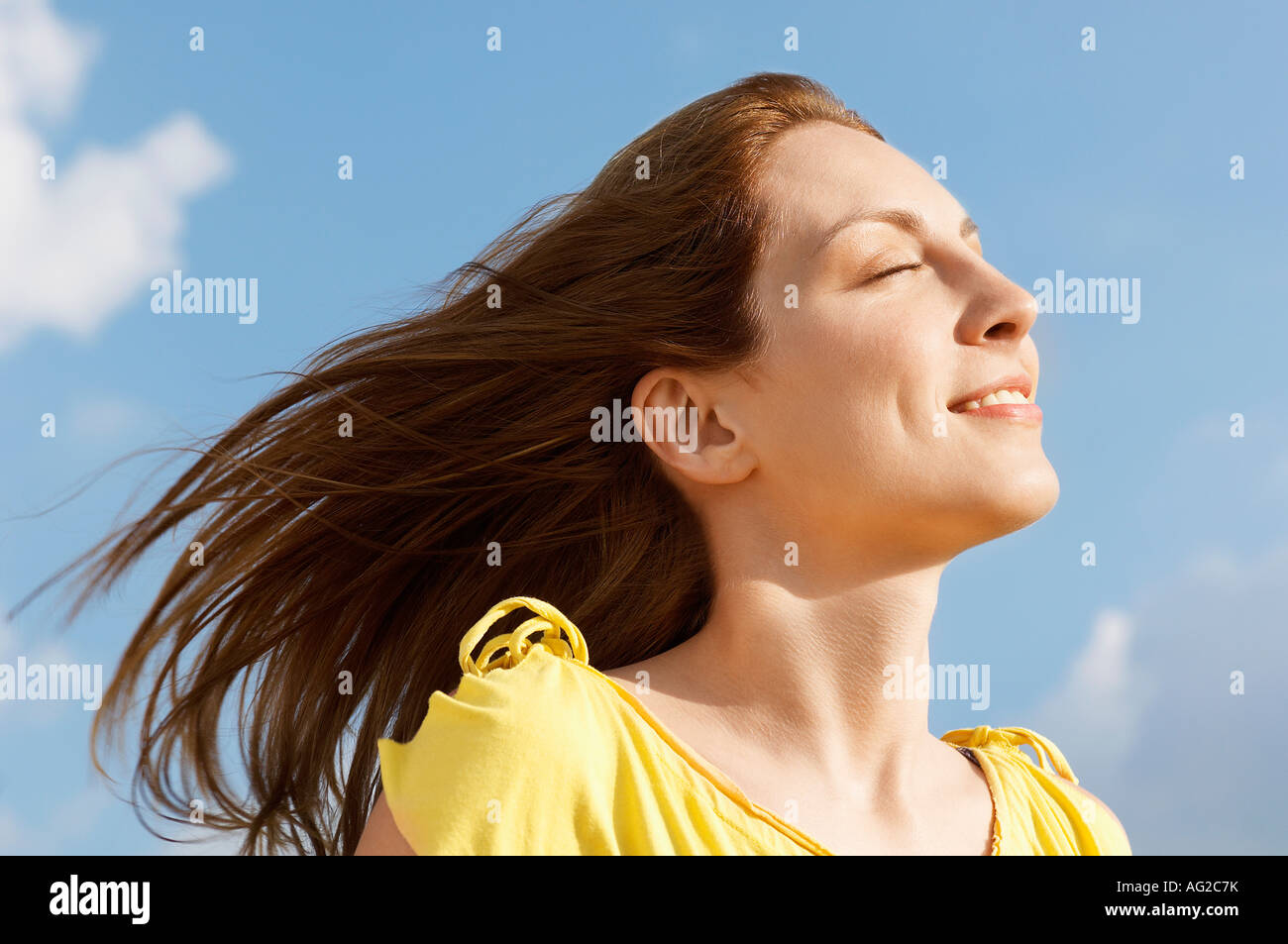 Young woman outdoors enjoying wind on face, close up Stock Photo - Alamy
