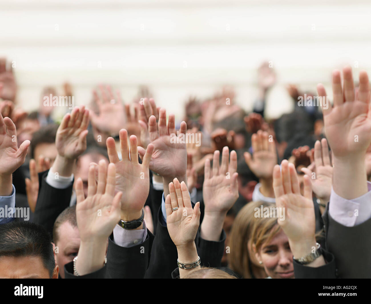 Crowd of people raising hands, focus on hands Stock Photo - Alamy