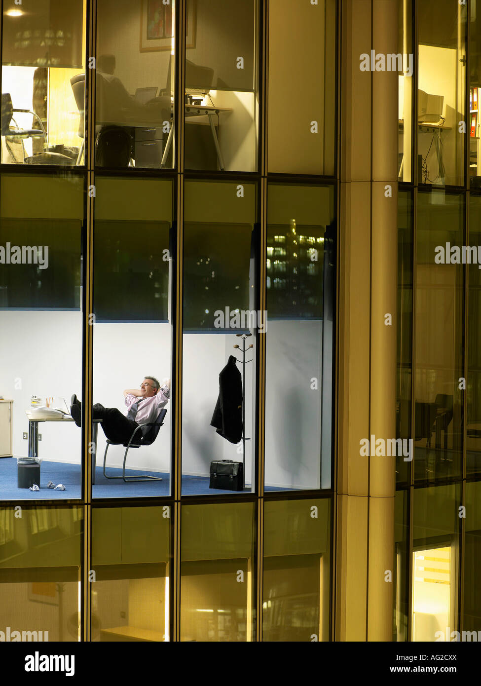 Business man relaxing in office, view from building exterior Stock ...