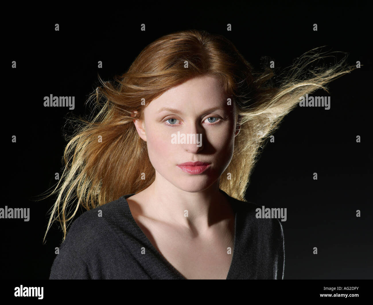 Windswept hair black background hi-res stock photography and images - Alamy