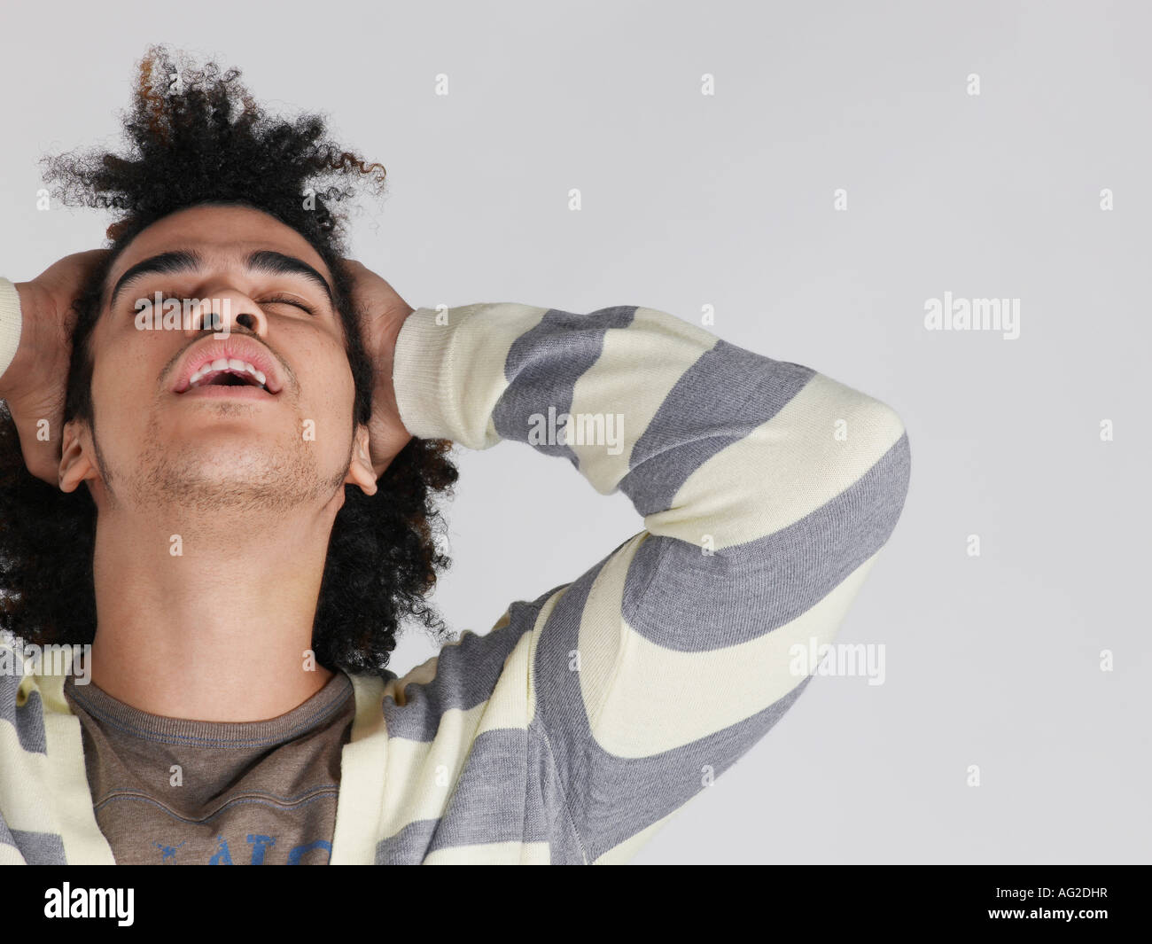 Young man pulling hair back Stock Photo - Alamy