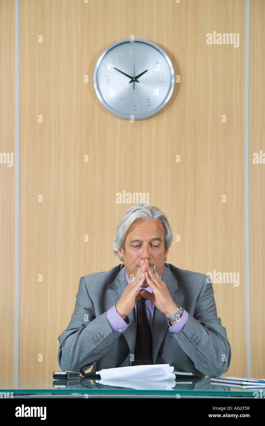 Business man reading papers in office Stock Photo - Alamy