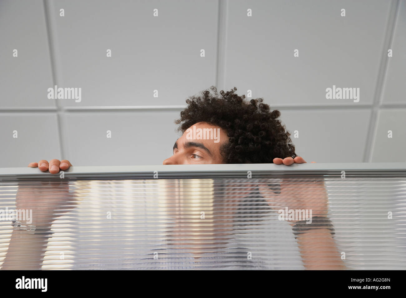 Man peeking over cubicle wall hi-res stock photography and images - Alamy
