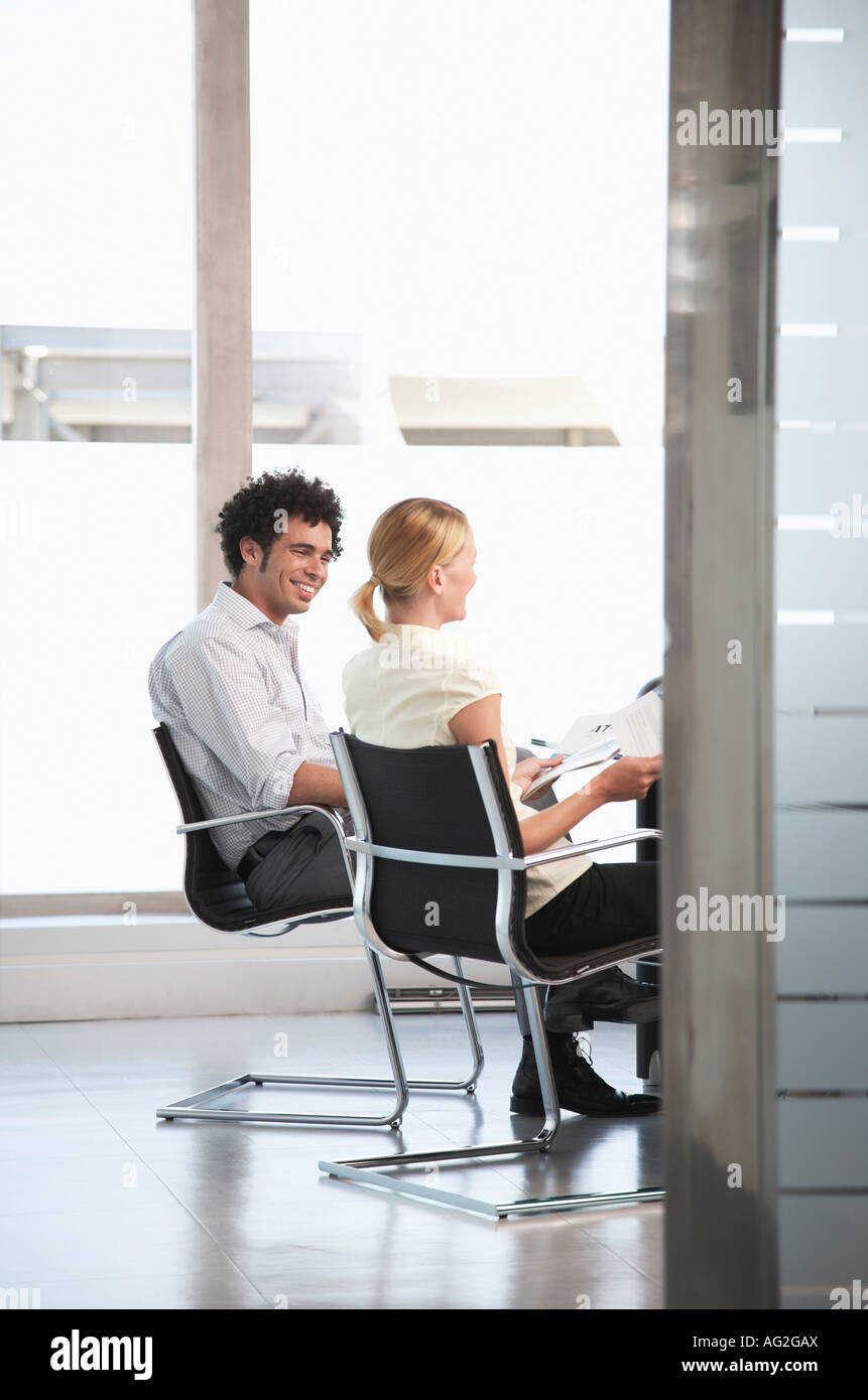 Two office workers sitting in conference room Stock Photo - Alamy