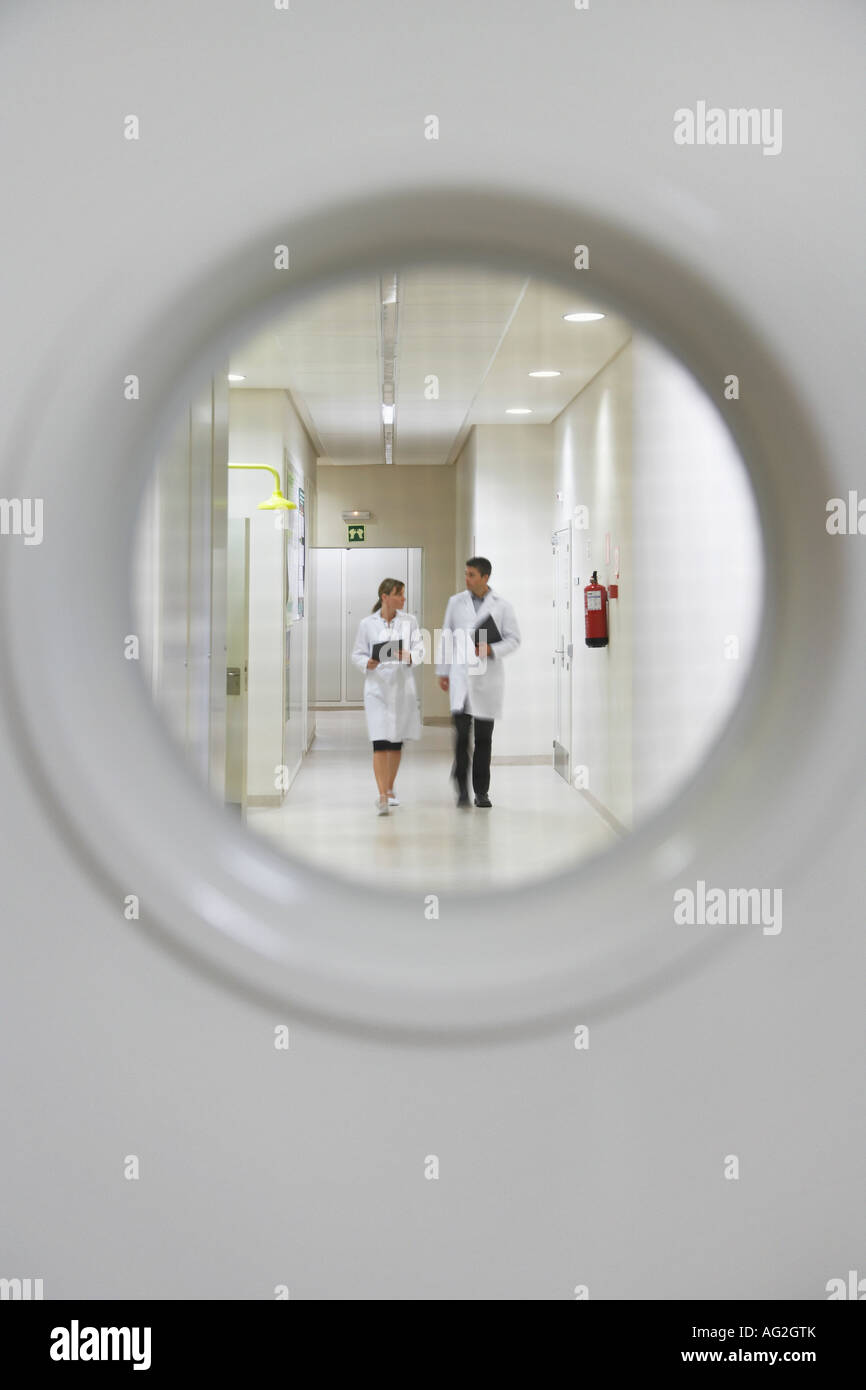 Two scientists walking down hallway, view from window in door Stock ...