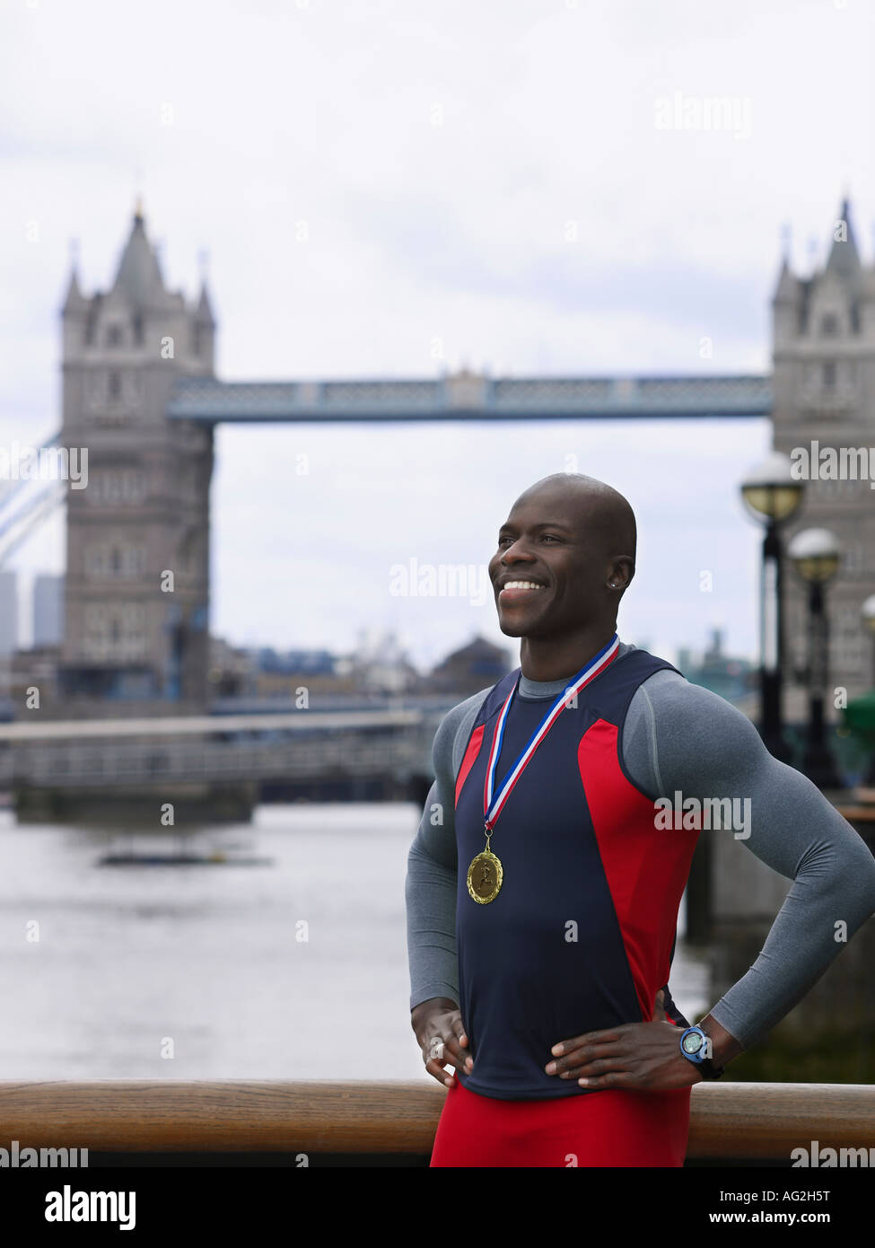 Man standing in front of Tower Bridge wearing medal, England, London ...