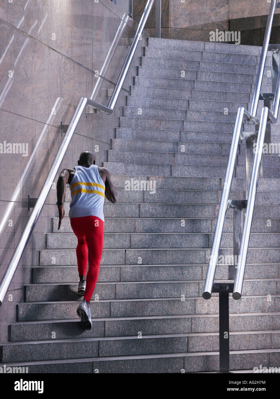 Male athlete running up staircase outside building Stock Photo - Alamy