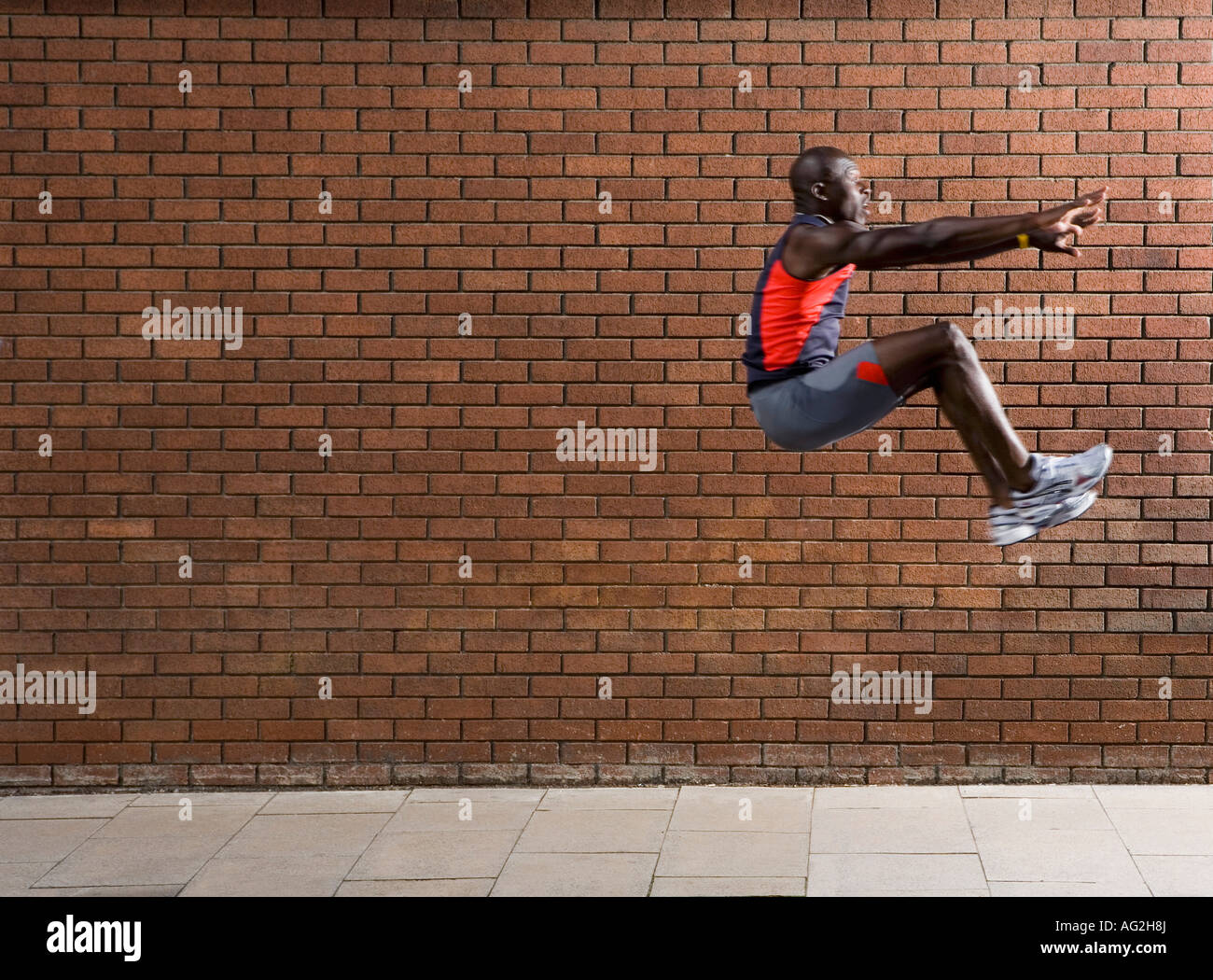 Man jumping by wall Stock Photo - Alamy