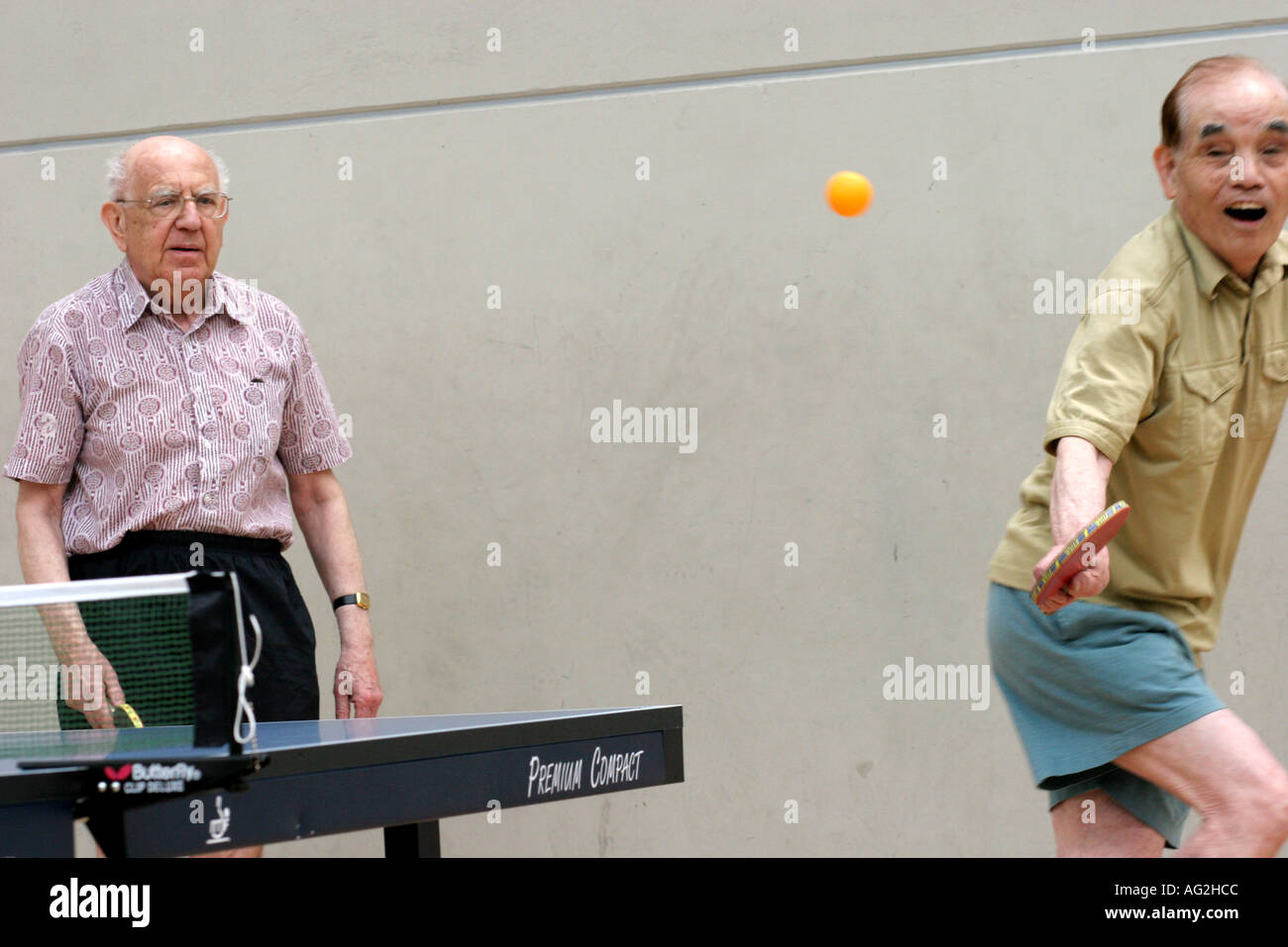 Two elderly men play ping pong Stock Photo - Alamy