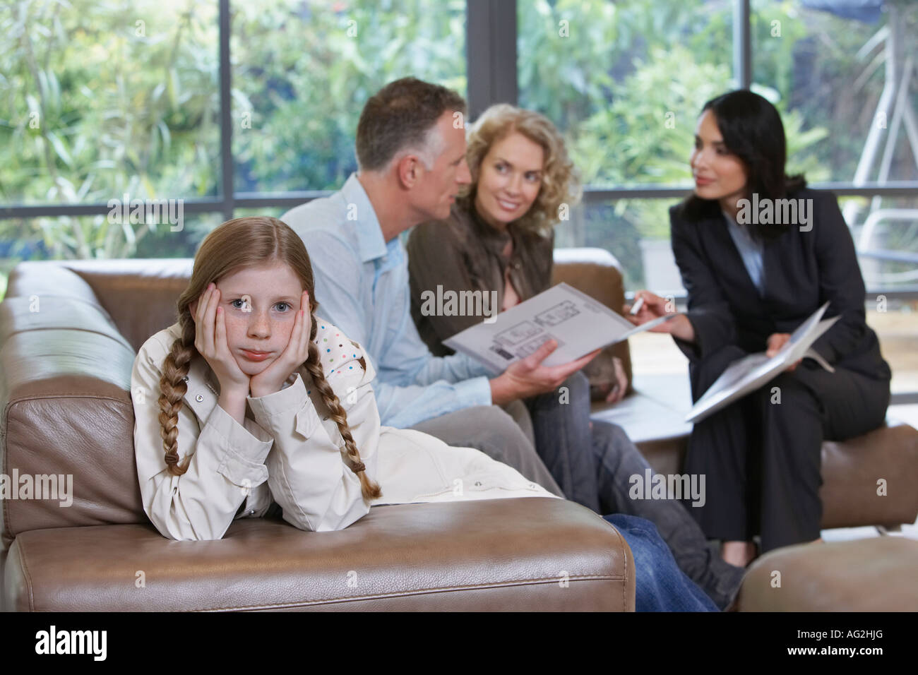 Parents with bored daughter (7-9) and estate agent, discussing new ...