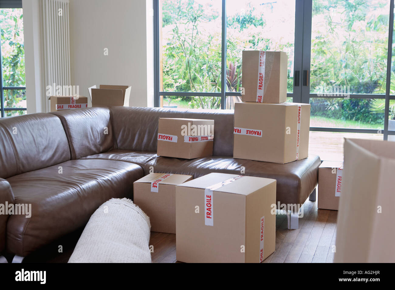 Cardboard boxes in living room of new home Stock Photo - Alamy