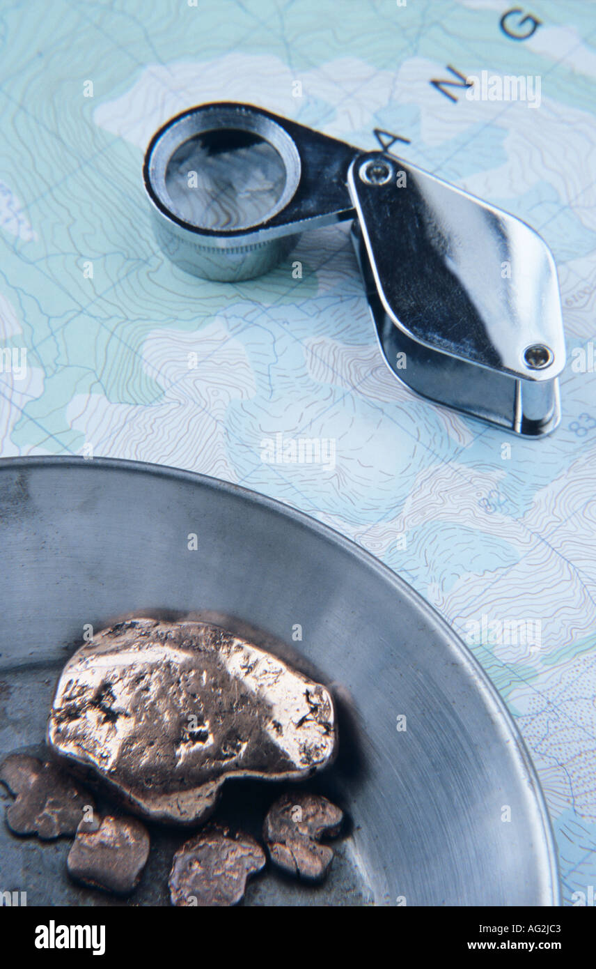 Mining concept image of copper nuggets magnifier and gold pan on map ...