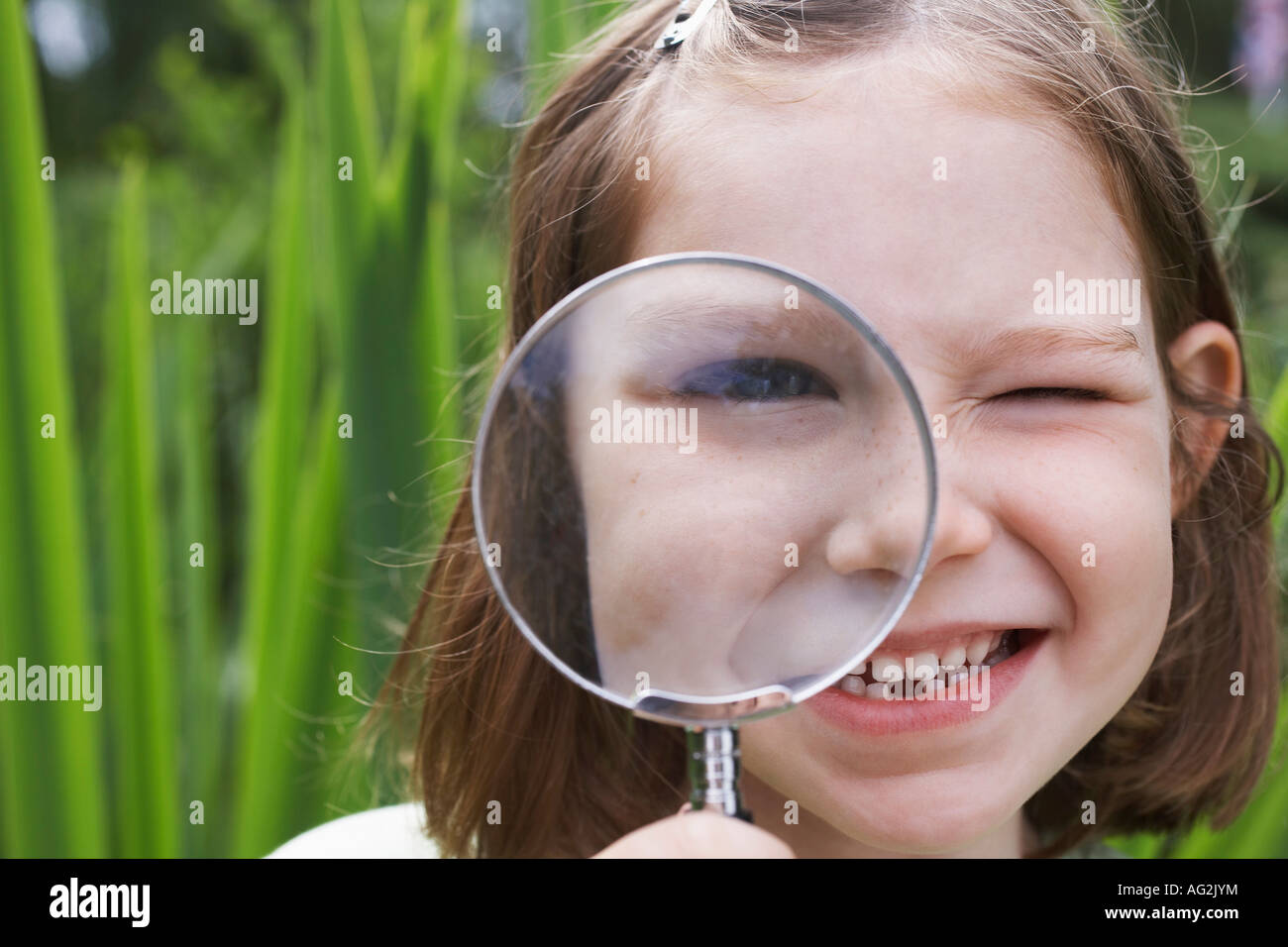 Child girl playing magnifying glass hi-res stock photography and images ...