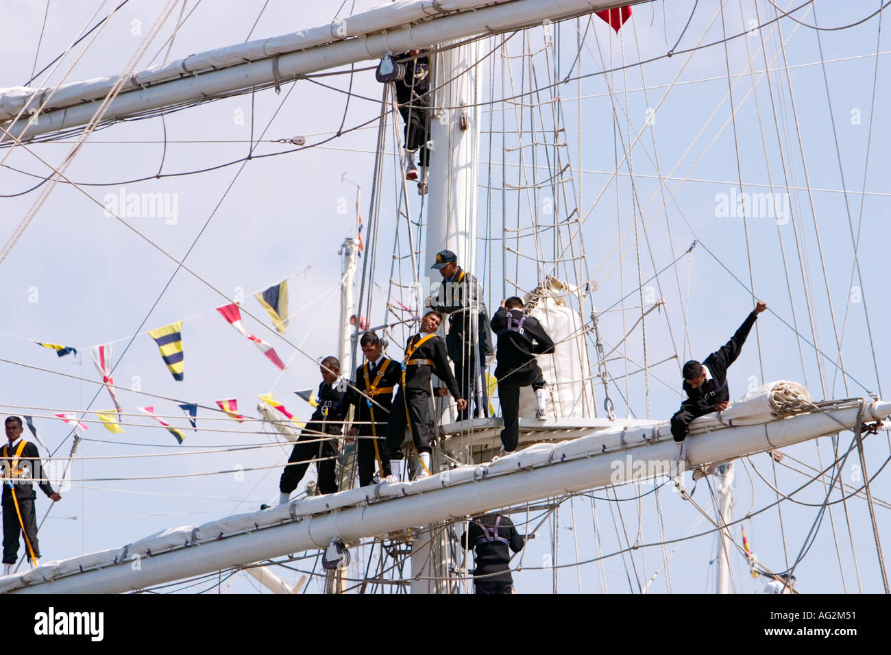 Crew members display on masts and sails of Indian Navy training ship ...