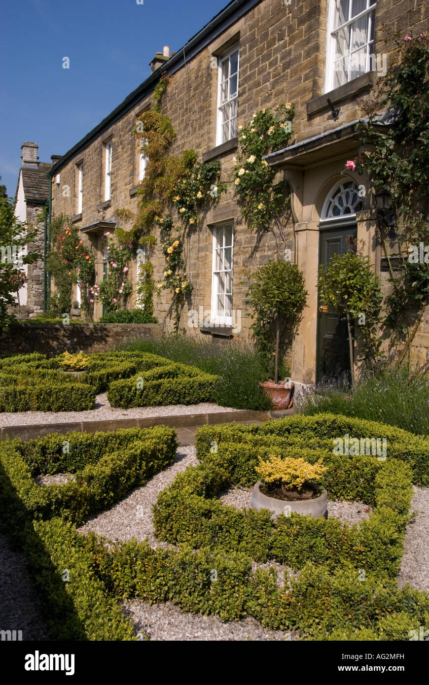 traditional english stone built country cottages with topiary garden in ...