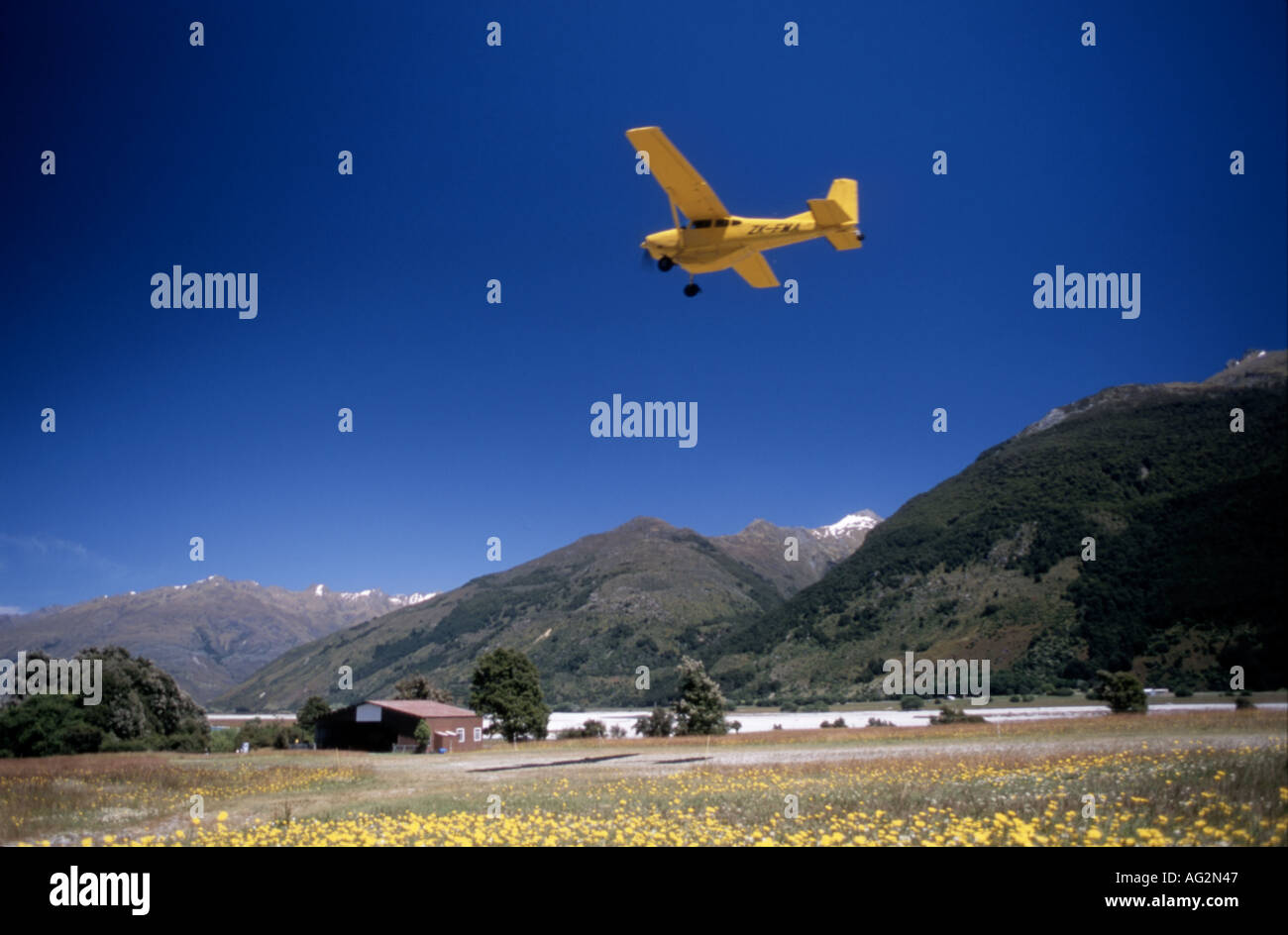 A bright yellow light aircraft used for flightseeing Makarora Otago New ...