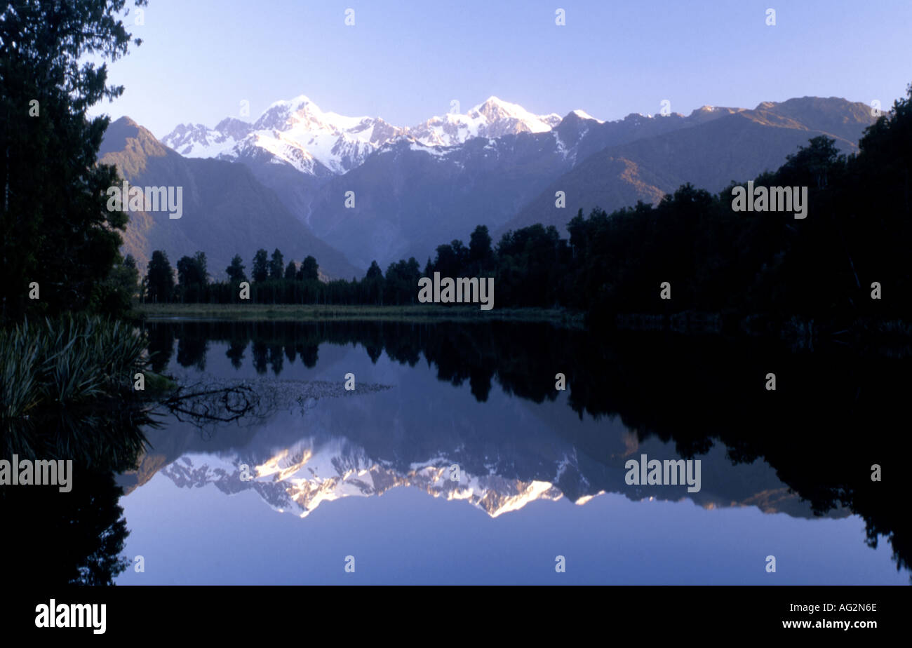 Reflected view of Mount Cook and range at dusk Lake Matheson West Coast ...