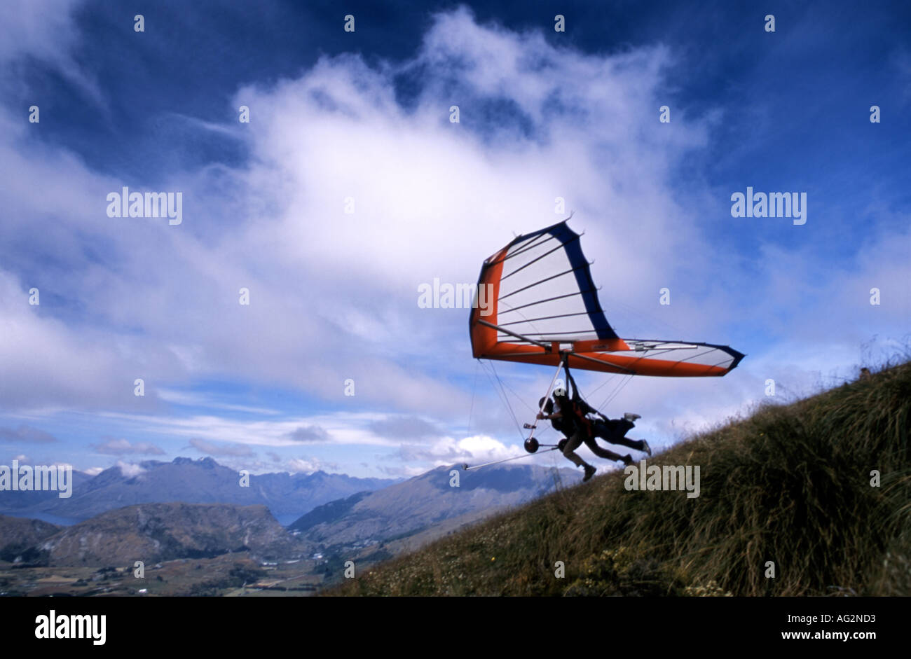 tandem hang glider taking off from hillside near Queenstown Otago New ...