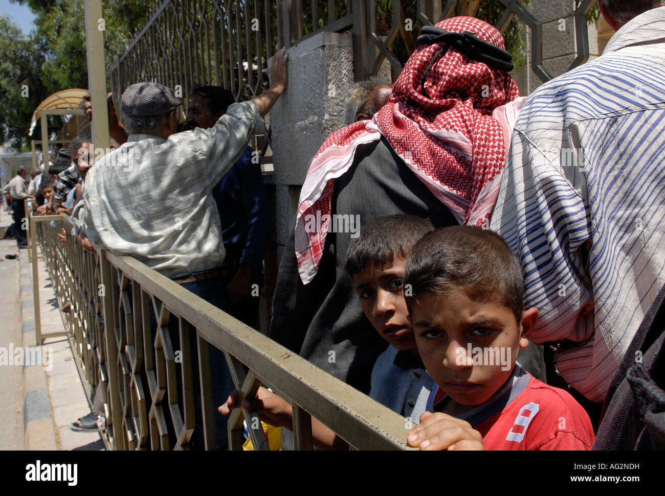 Iraqi refugees stand in line outside UNHCR United Nations Higher ...