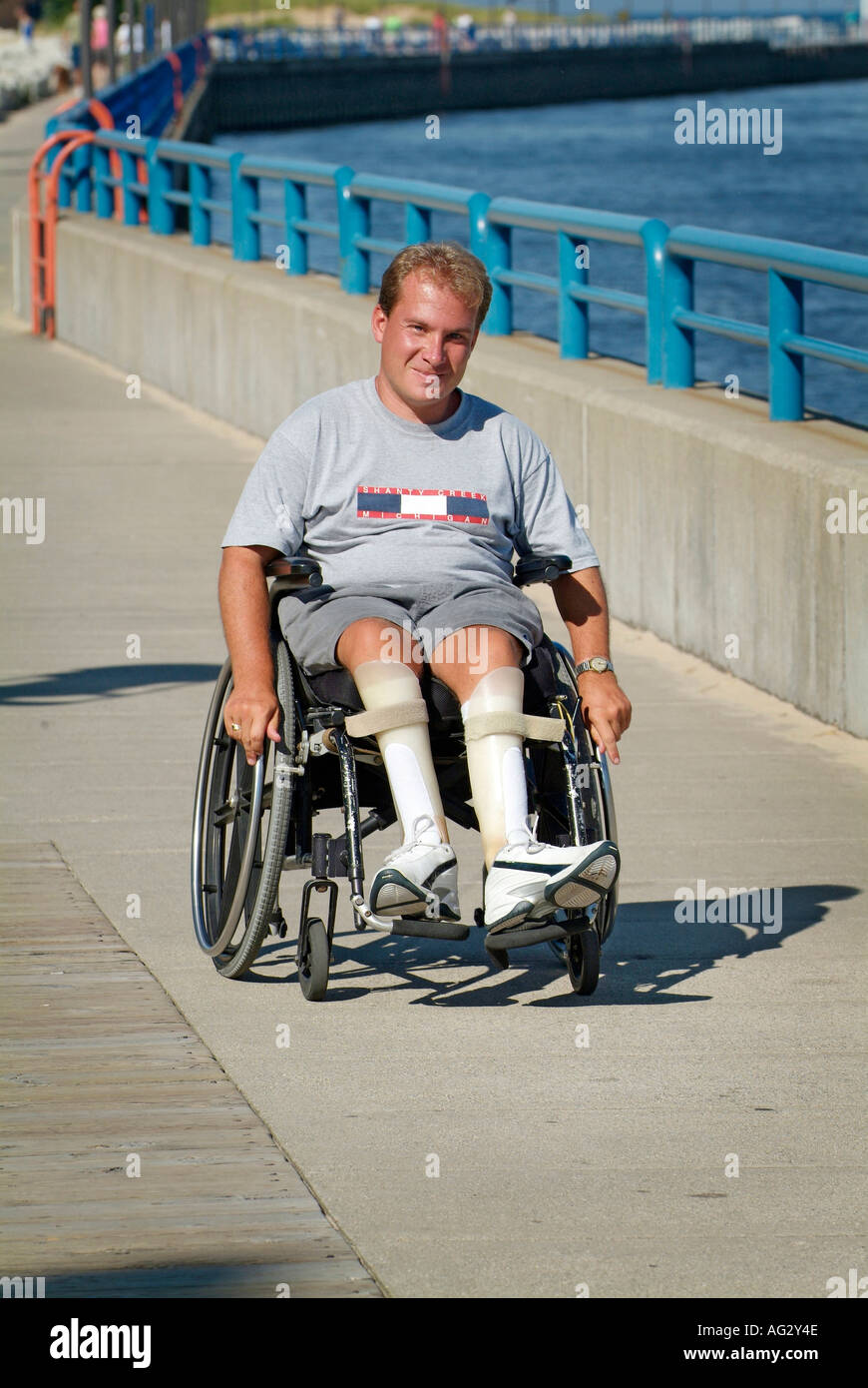 Handicapped male exercises at Grand Haven State Park on Lake Michigan ...
