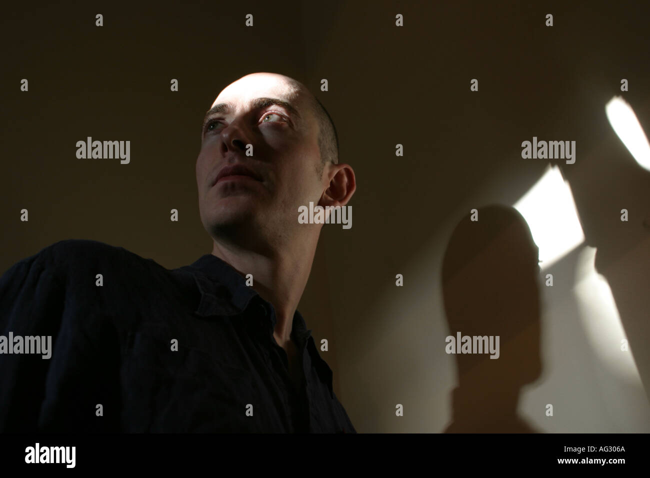 Man with very short hair in shadow and highlights Stock Photo - Alamy