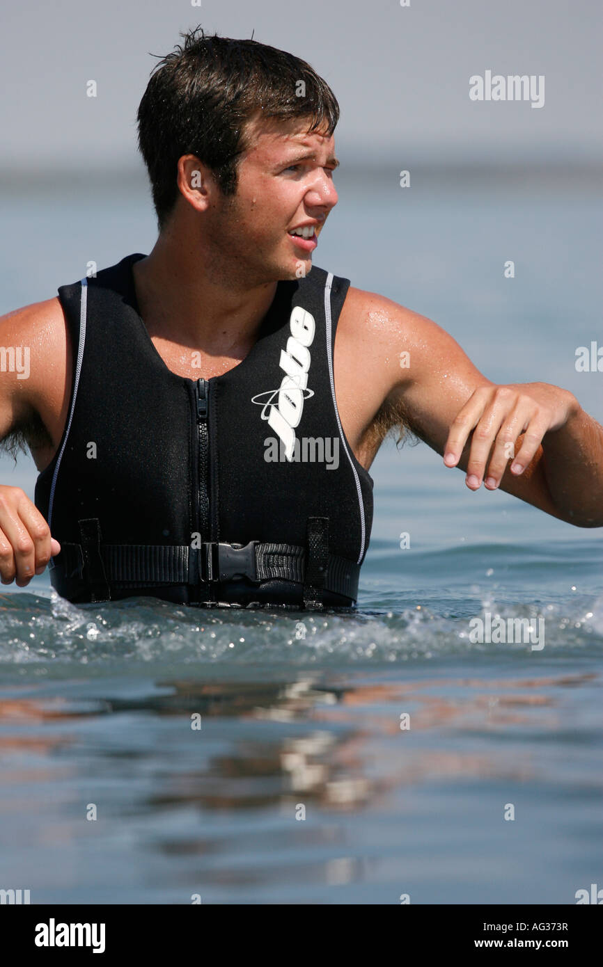 Teenage boy standing in waist deep water Stock Photo - Alamy