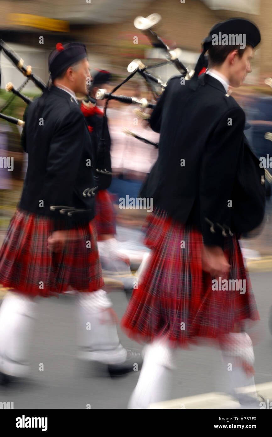 Scottish bagpipers in tartan kilts marching in street parade Stock ...