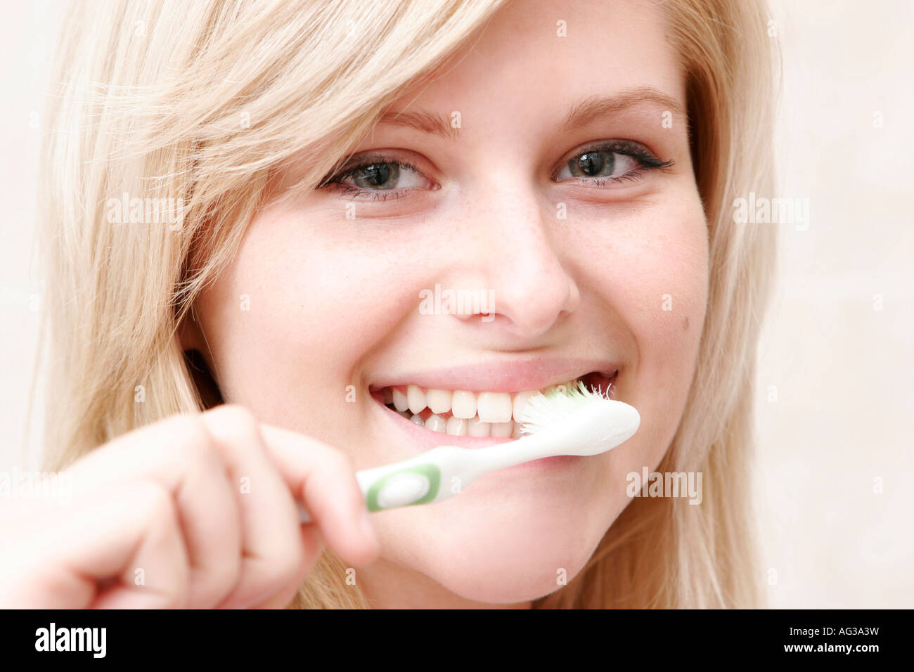 A young woman is brushing teeth with toothbrush Stock Photo - Alamy