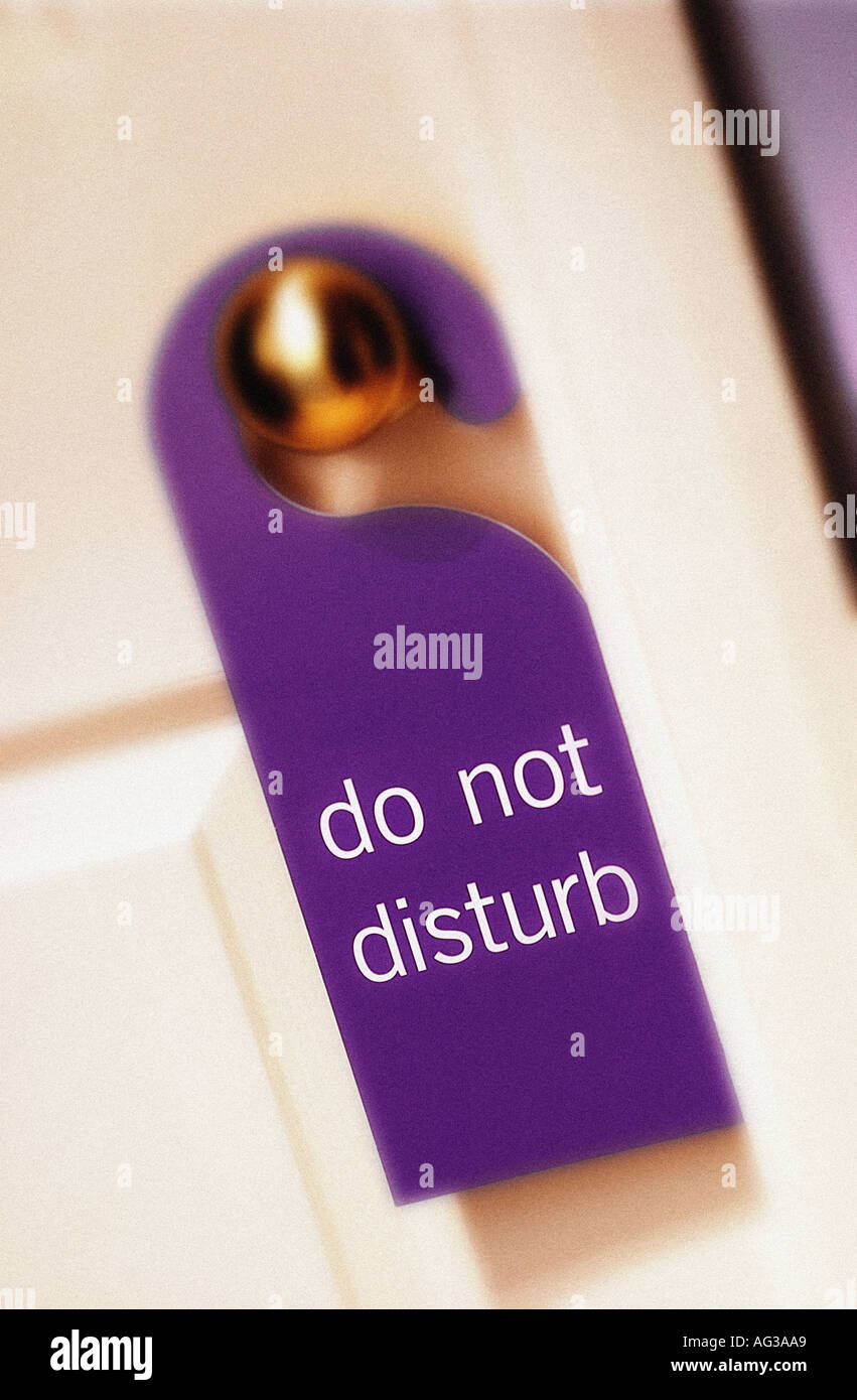 Do Not Disturb sign hanging on door knob Stock Photo - Alamy
