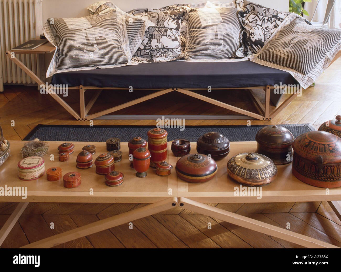 Collection of antique treen boxes on wooden table in front of folding ...