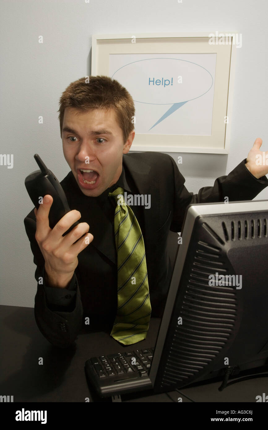Businessman screaming into a phone Stock Photo - Alamy