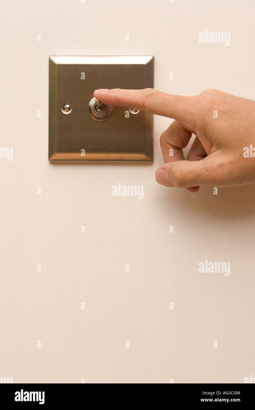 Male hand switching off a wall mounted light switch Stock Photo - Alamy