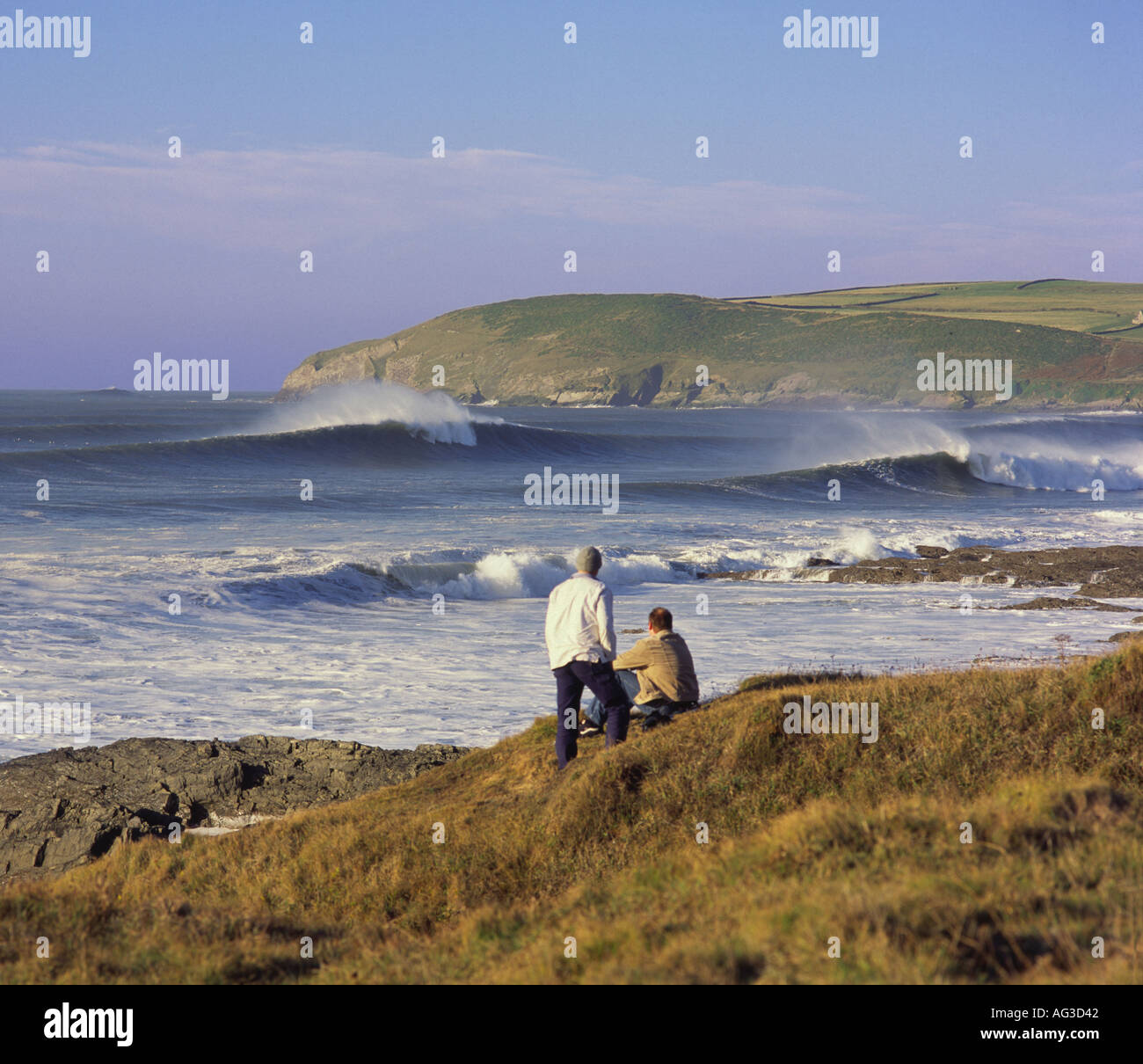 Spectacular classic surfing waves breaking at Croyde Bay with two men ...
