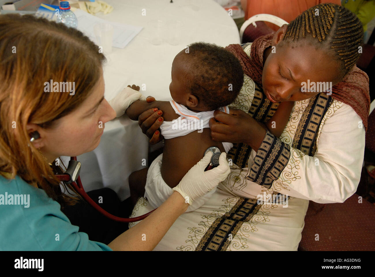 An Israeli doctor examines a young toddler during medical assistance of African asylum seekers ...