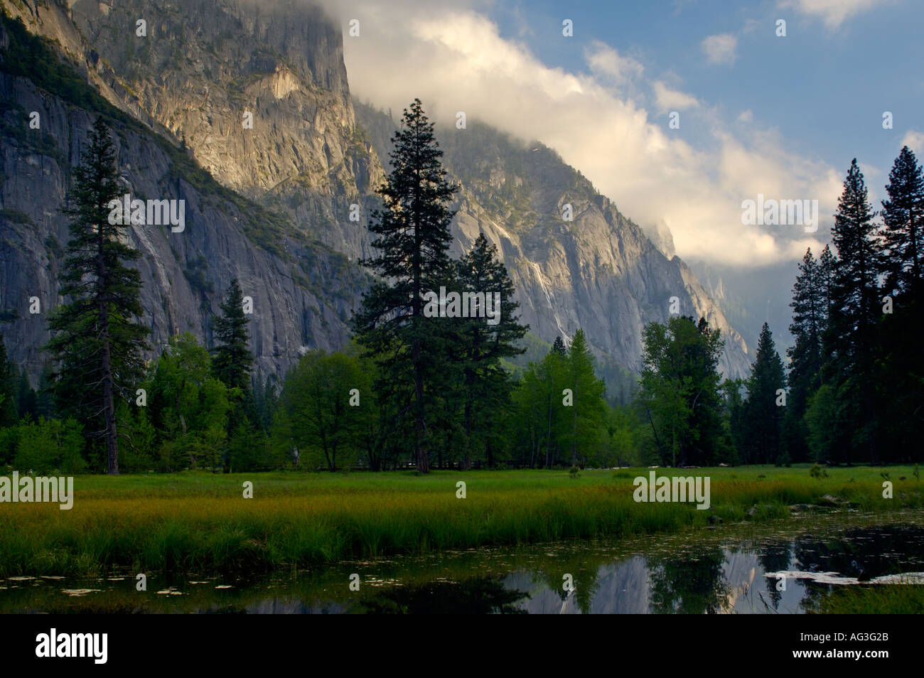 Storm clouds at sunset shroud the sheer cliff walls of Sentinel Rock ...