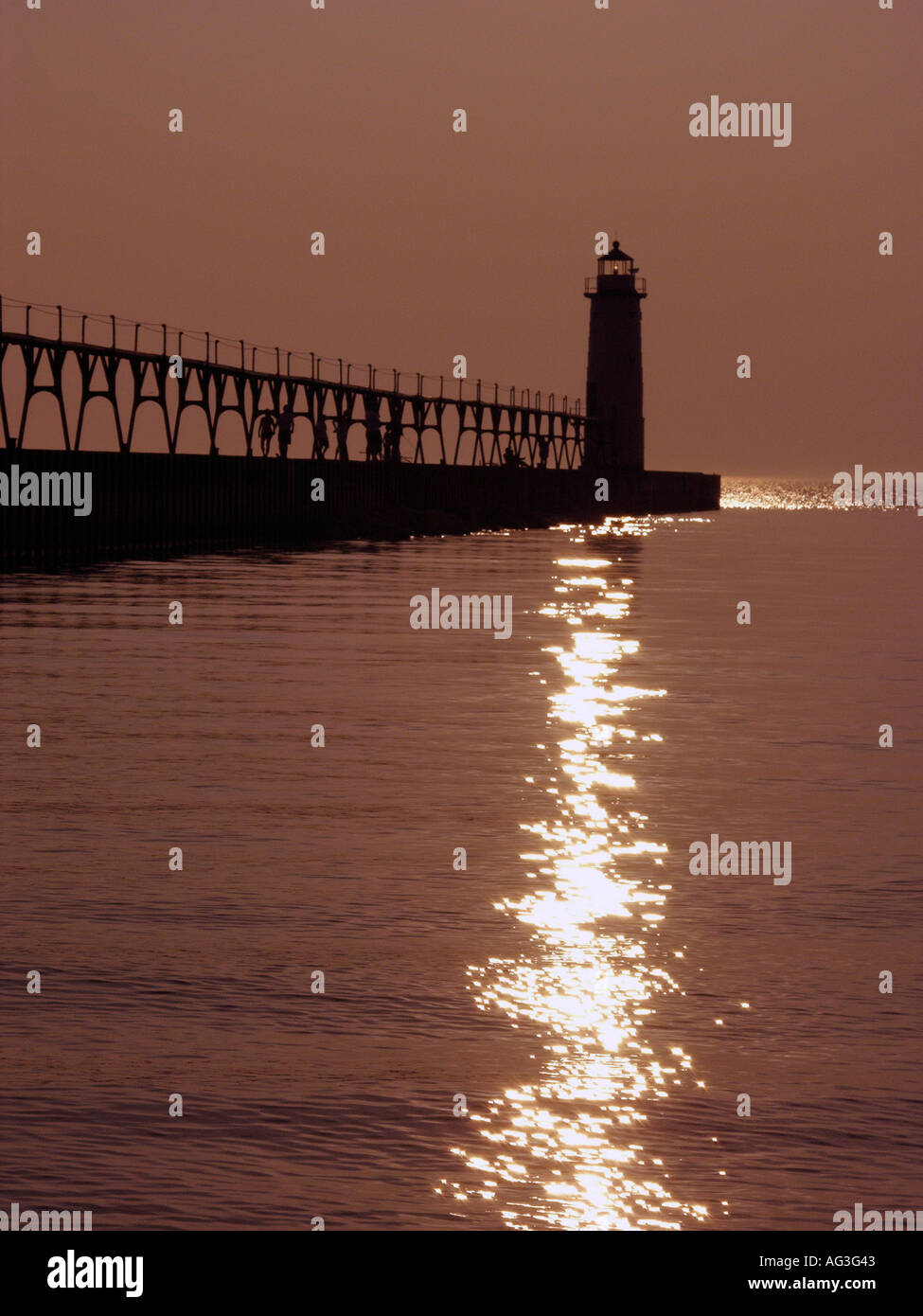 Sunset behind the lighthouse on Lake Michigan at Manistee Michigan ...
