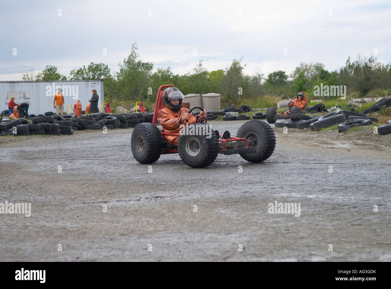 Cross cart driving on a ground track with tires as fence Stock Photo ...
