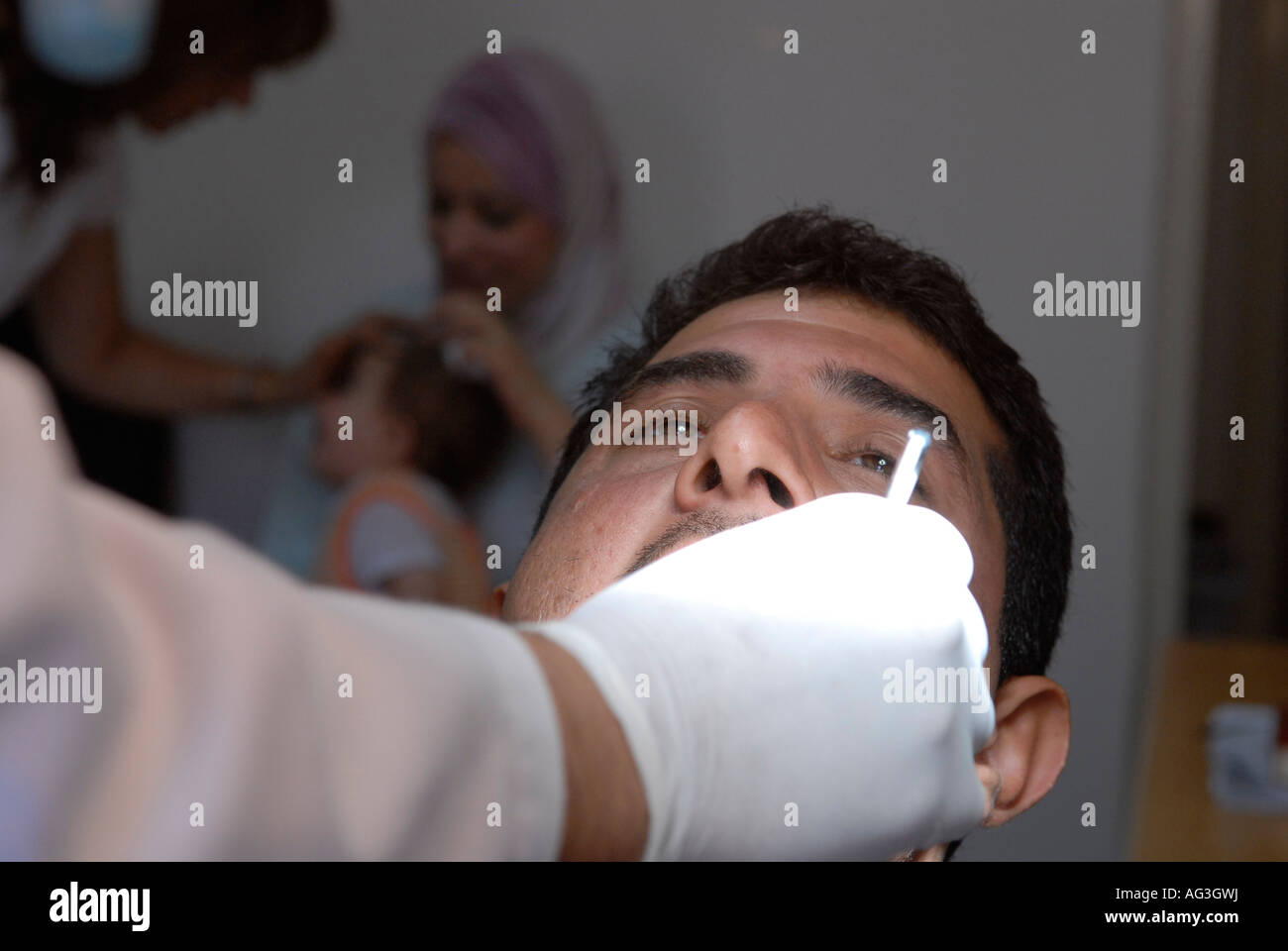 Patient being treated by a dentist at a dental clinic operated by ...