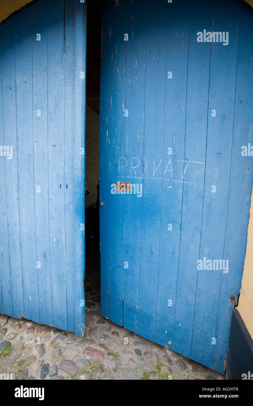 Blue Door Private A pair of bright blue wooden doors over a cobbled ...