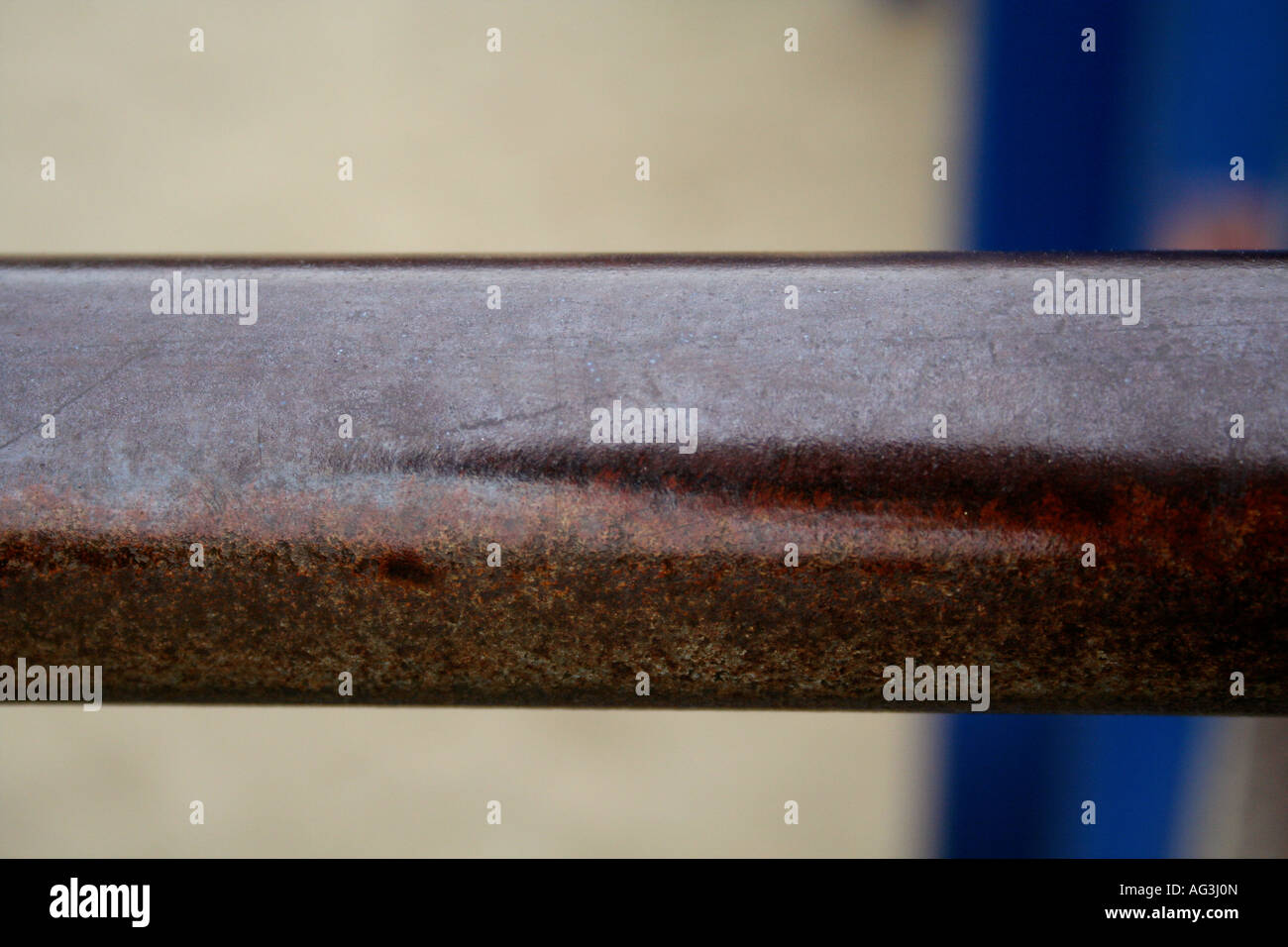 Red rusty bar close up with a blue and beige blurred background Stock ...