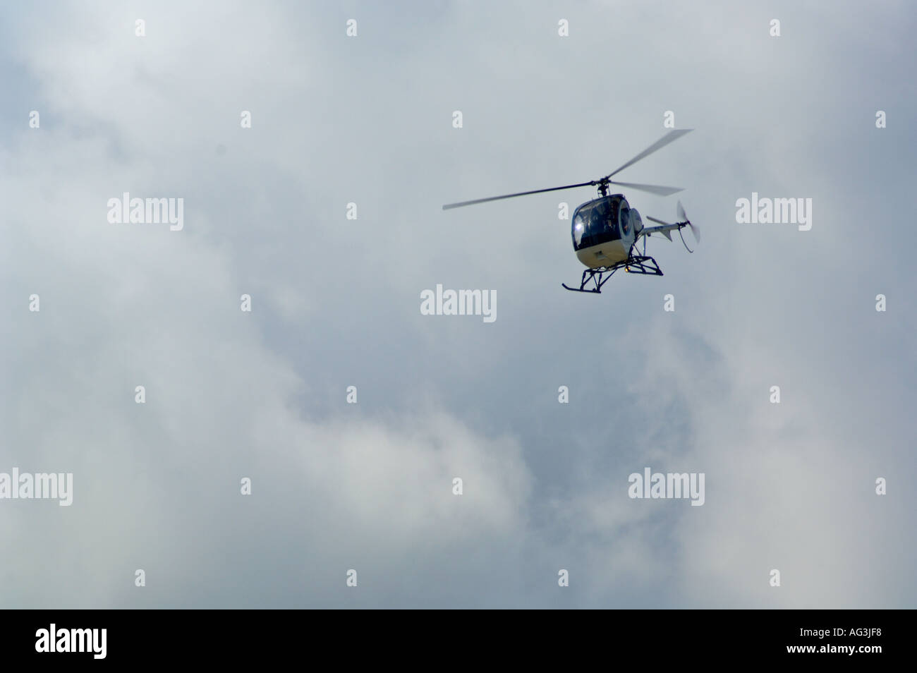 Small SCHWEIZER 269c 1 rotorcraft helicopter flying in clouds ...