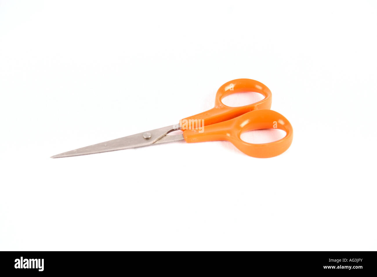 orange handled metal scissors on white background Stock Photo - Alamy