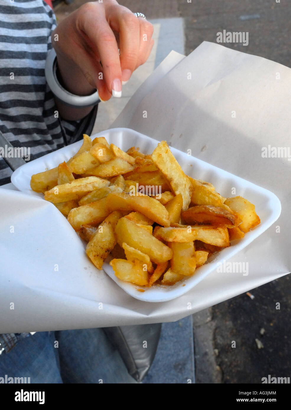 Woman Eating a Portion of Chips Stock Photo - Alamy