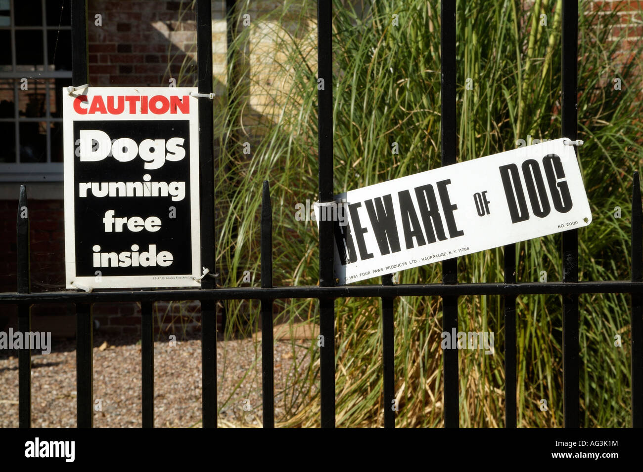 Beware of the Dog and dogs running free sign on a Metal Gate Stock ...